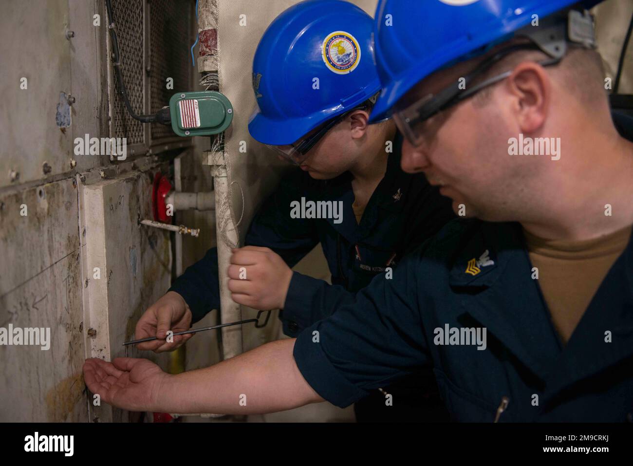 U.S. Navy Electrician’s Mate (Nuclear) 3rd Class Andrew Kitzman, left ...