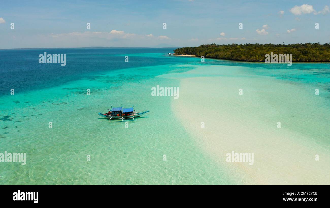 Seascape with a beautiful beach and tropical island surrounded by a ...