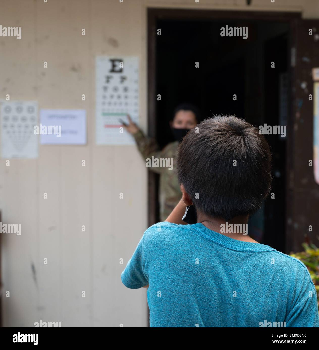 A young patient performs a sight test with U.S. Air Force Staff Sgt ...
