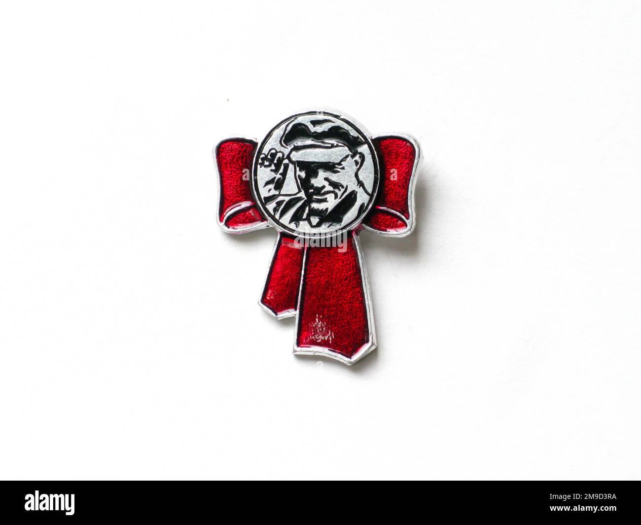 This badge from the former Soviet Union shows Lenin, his hand raised in ...