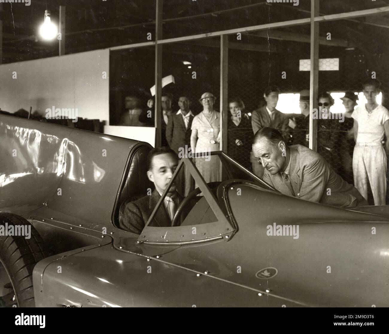 A driver sitting in Blue Bird cockpit look at instrument panel with ...