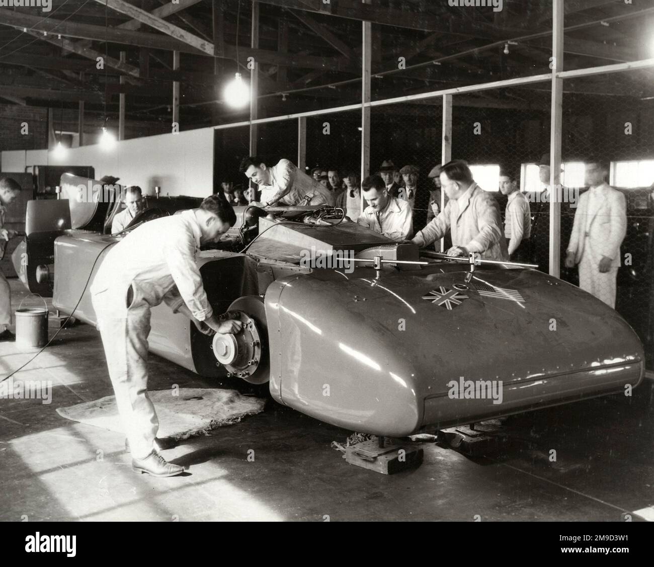 Blue Bird on chocks being worked on by mechanics in workshop building ...