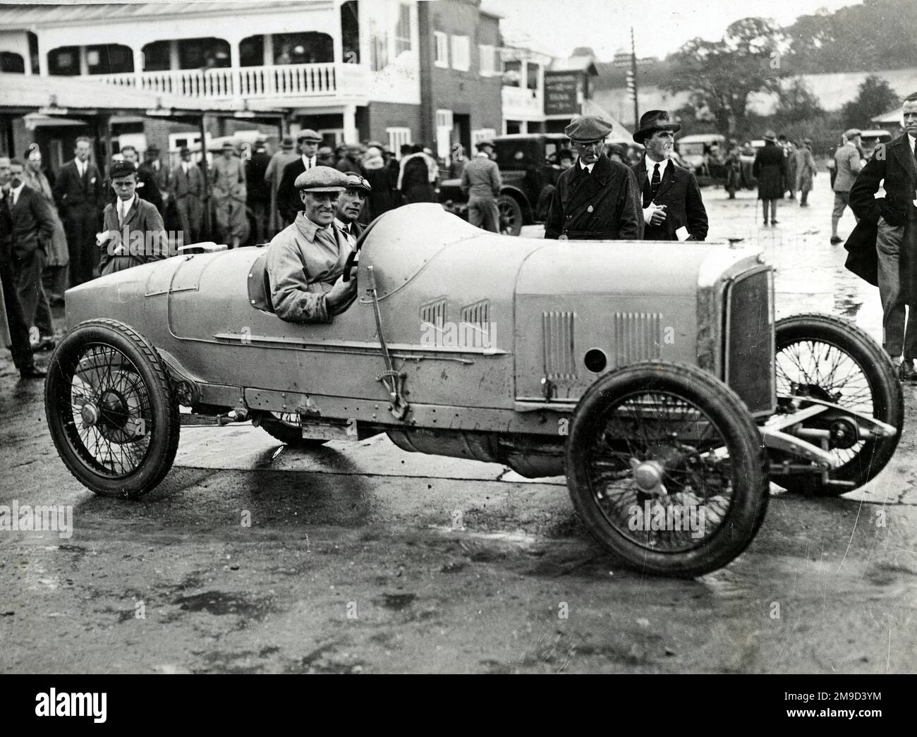 Two litre Itala at Brooklands by the racing bays, with clubhouse and ...