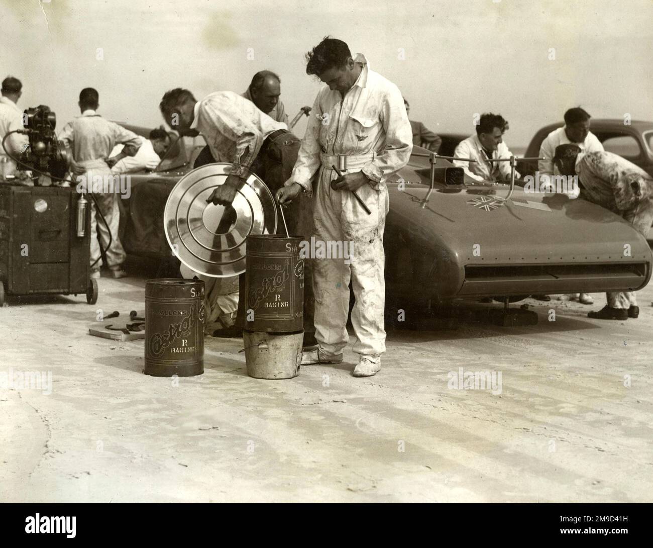 Blue Bird parked on sand with mechanics Castrol oil cans and test ...