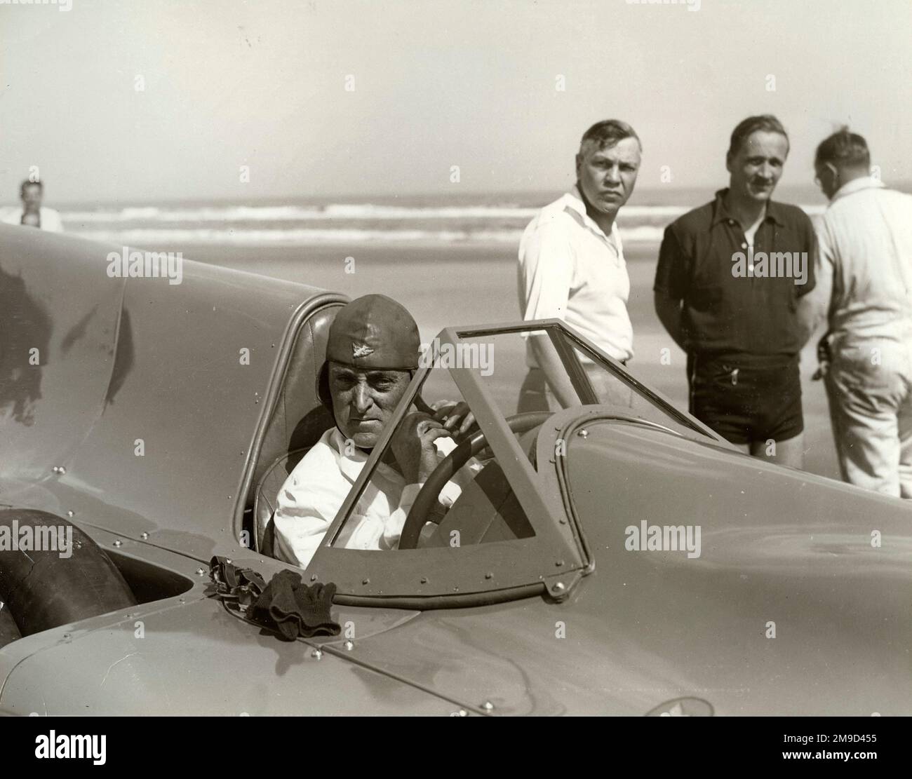 Side view of Campbell sitting in Blue Bird with 3 others watching Stock ...
