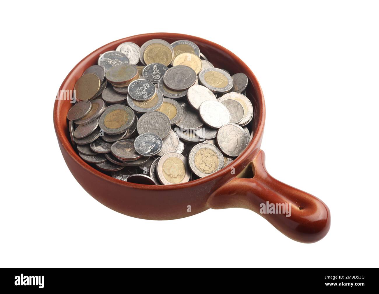 Coins in a ceramic cup on a white background Stock Photo - Alamy