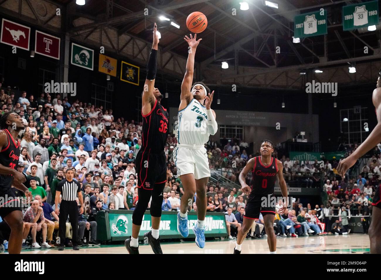 Tulane guard Jalen Cook (3) shoots between Houston forward Reggie ...