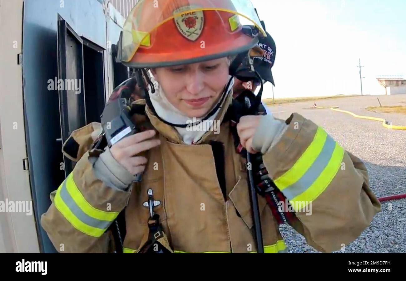 Rachel Feld, an intern at USAG Fort Sill, dons firefighting equipment ...