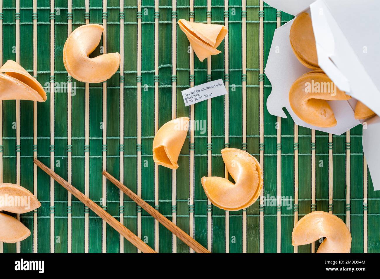 Fortune cookies on a bamboo mat with chopsticks and a fortune Stock ...