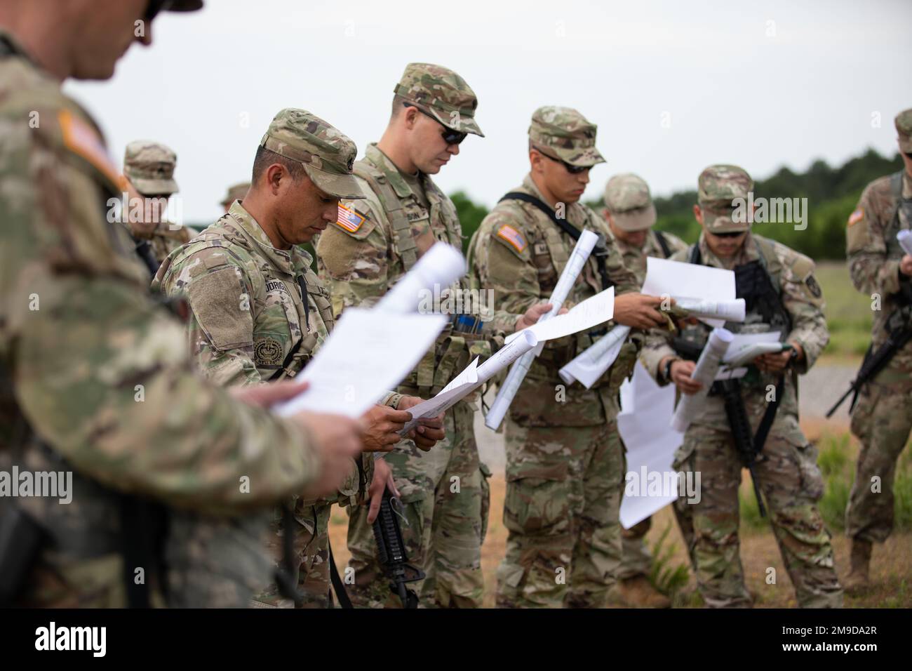 Army National Guard Soldiers look at maps as they begin the land ...