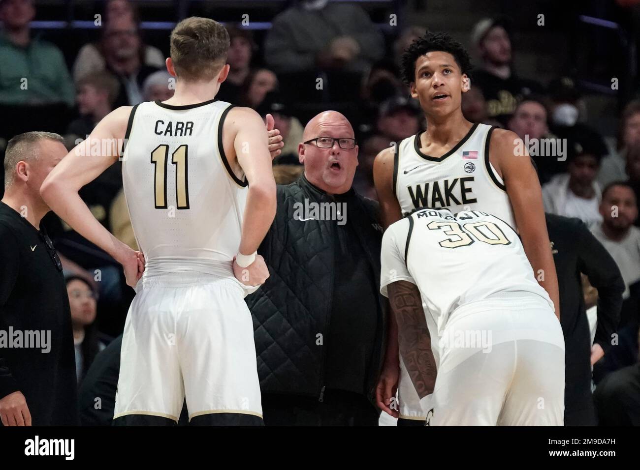 Wake Forest head coach Steve Forbes, center, talks to players during a ...