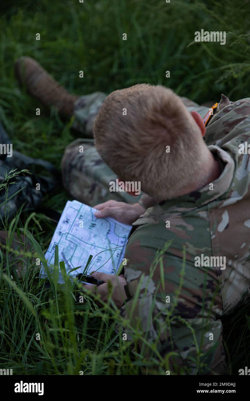 An Army National Guard Soldier plots points on a map during the night ...