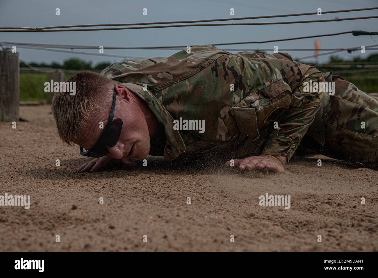 Staff Sgt. Spencer Grayson, Oklahoma National Guard, crawls through an ...