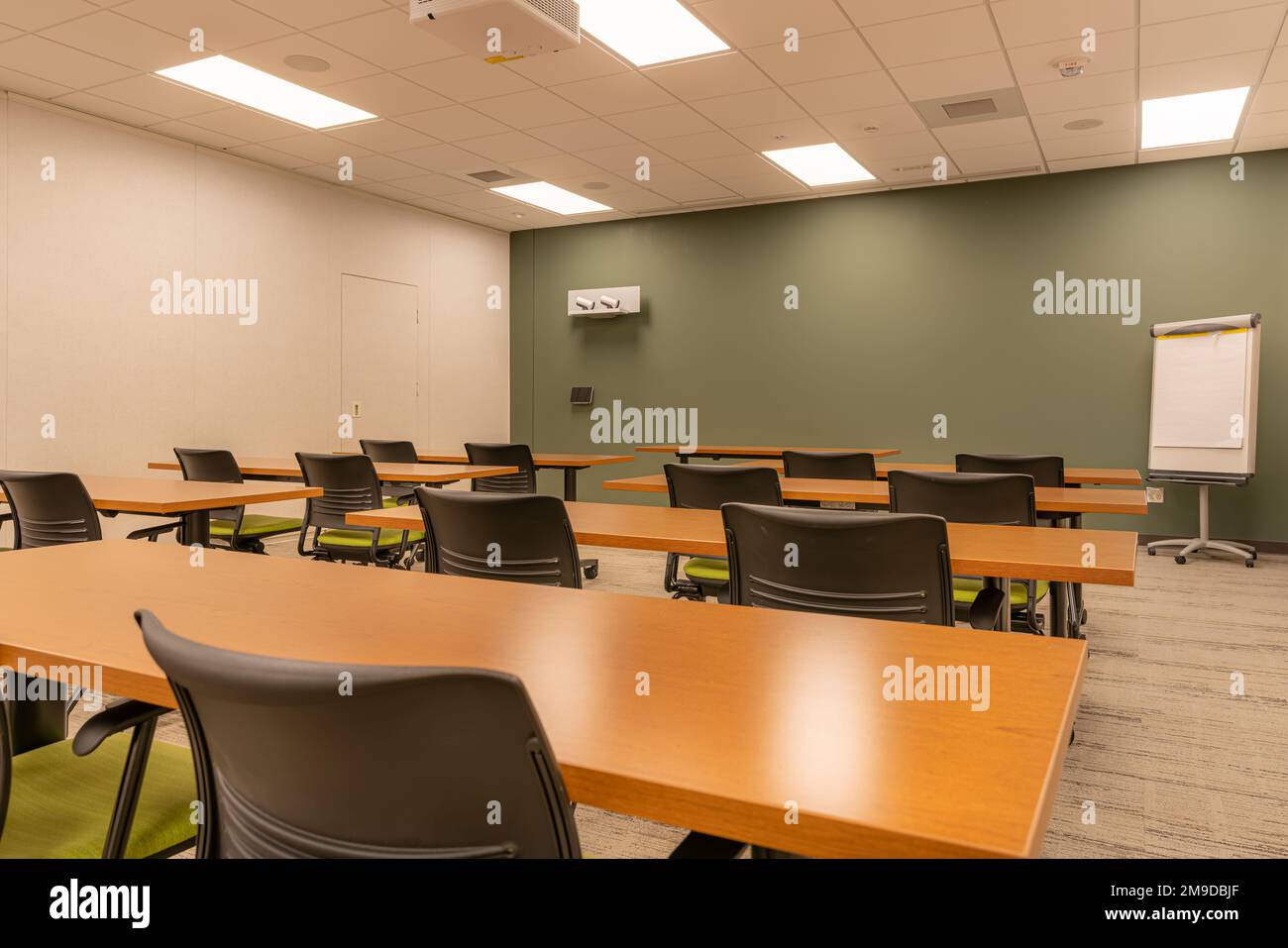 Interior of an office training, meeting, conference room with desks ...