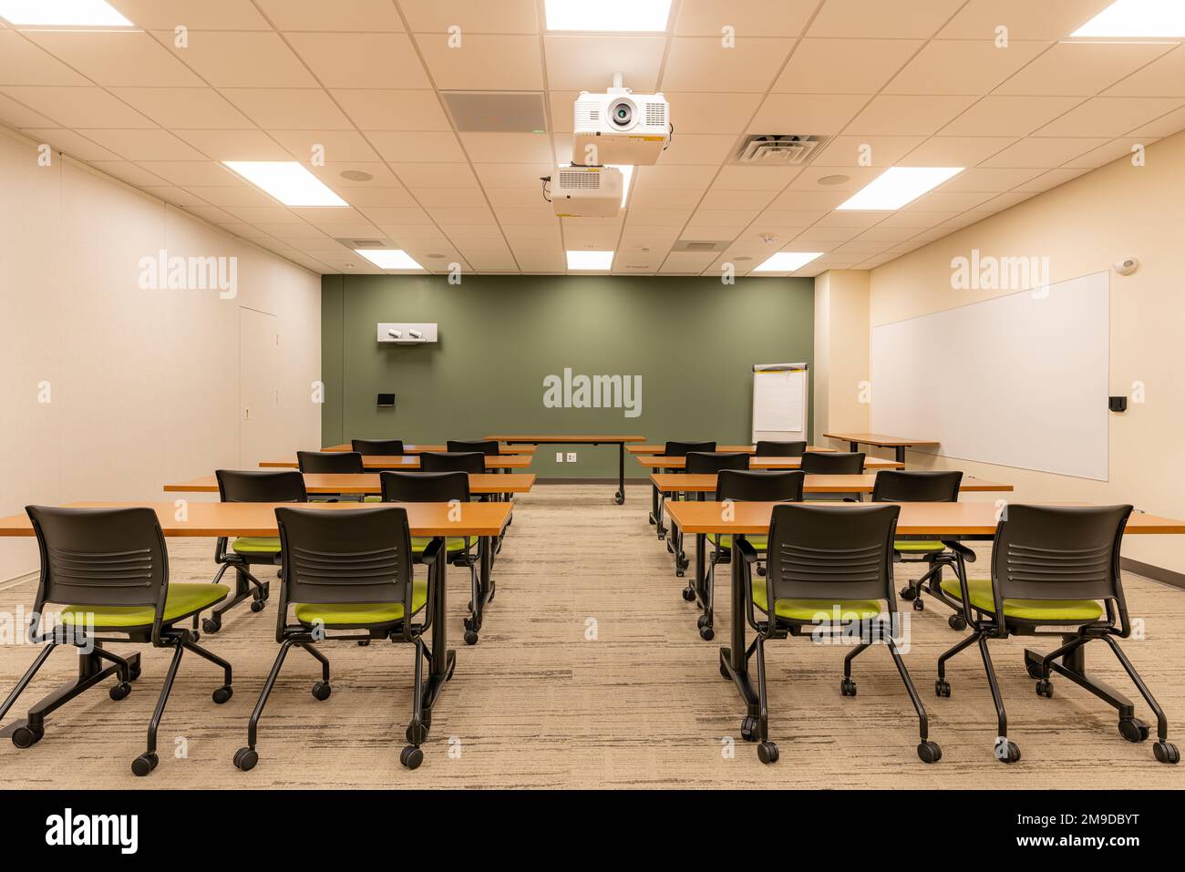Interior of an office training, meeting, conference room with desks ...