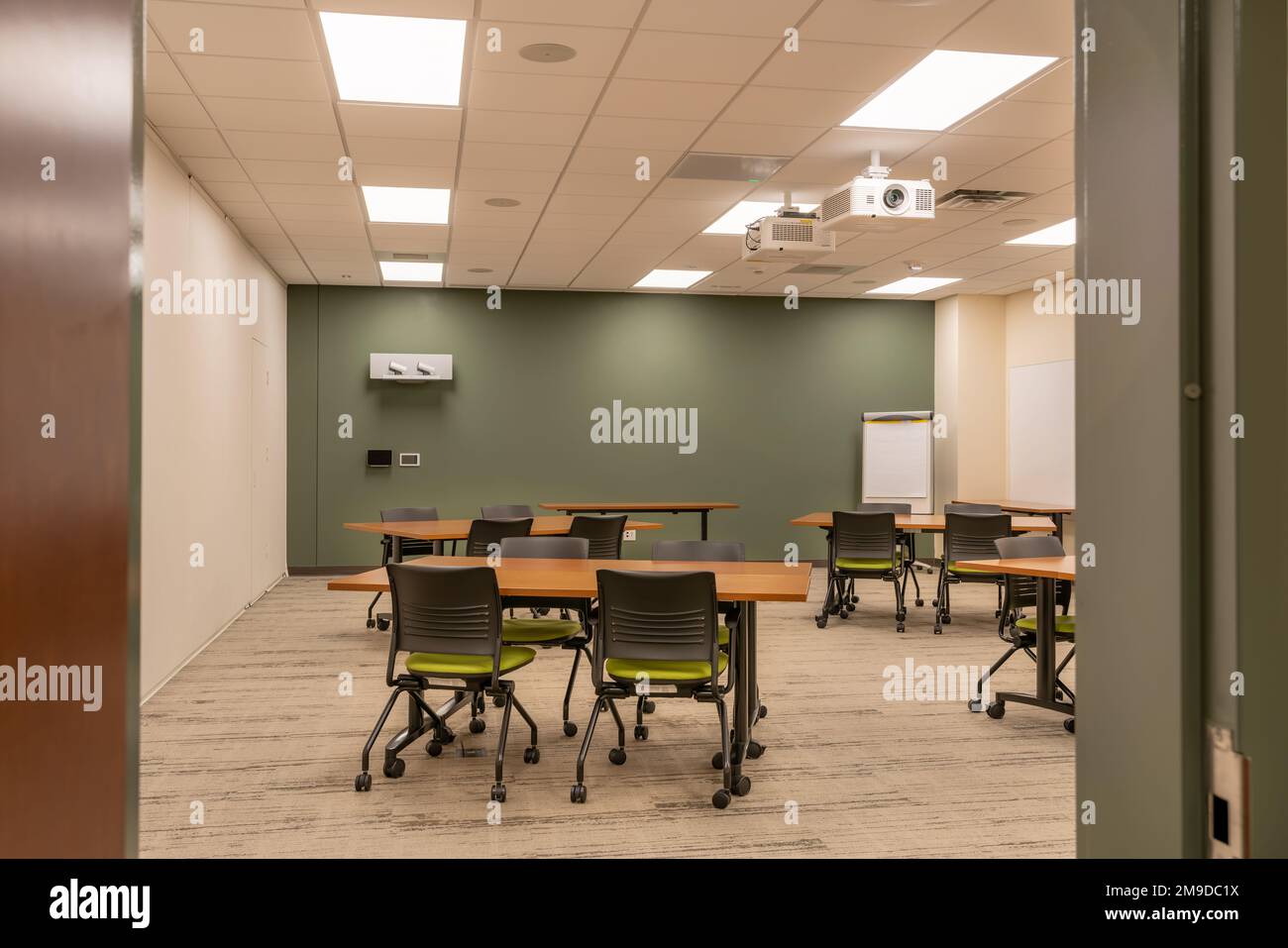 Interior of an office training, meeting, conference room with desks ...