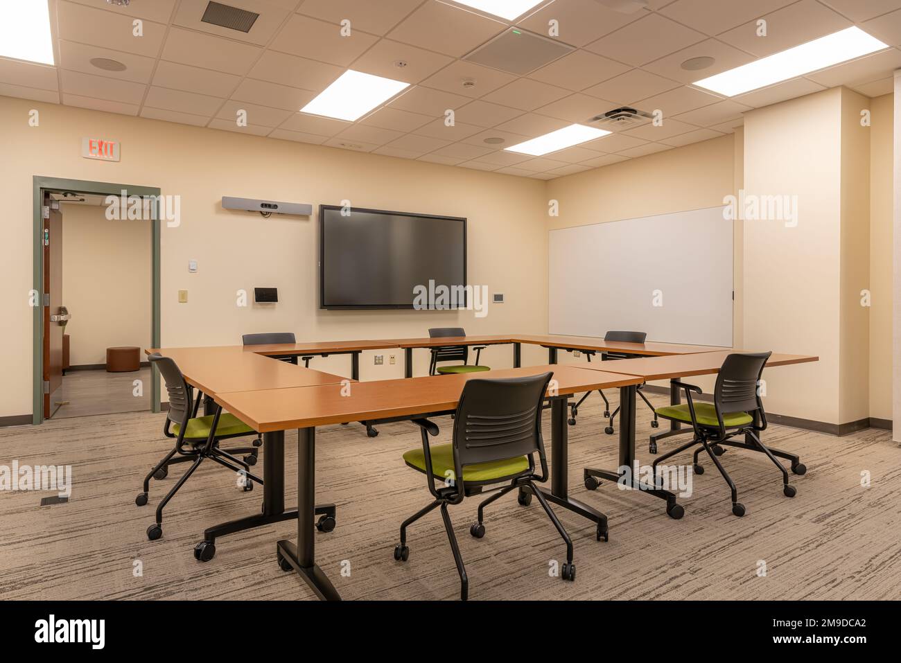Interior of an office training, meeting, conference room with desks ...