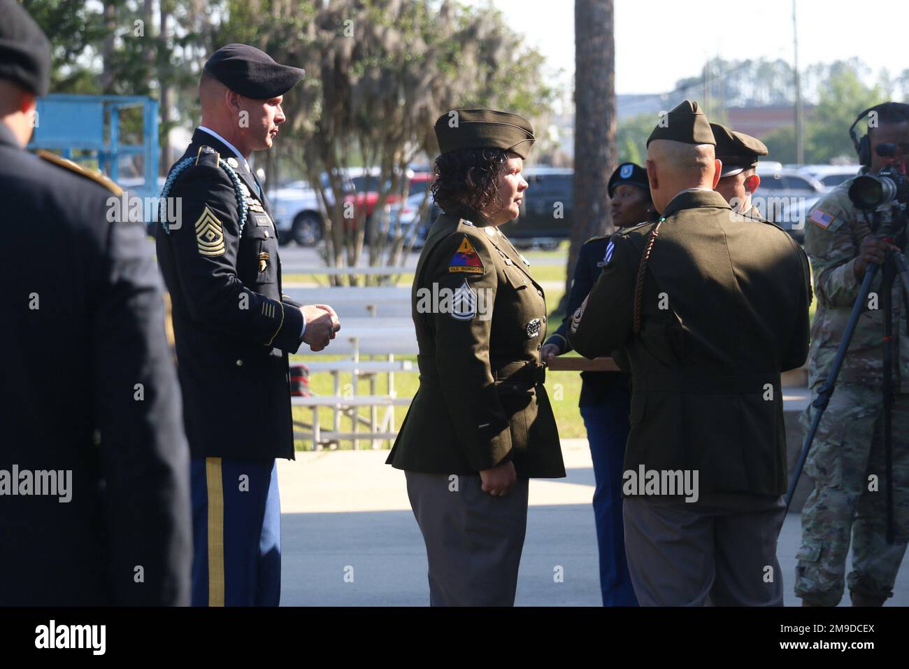 Sgt. 1st Class Yolesi Garcia, center, assigned to Headquarters and ...