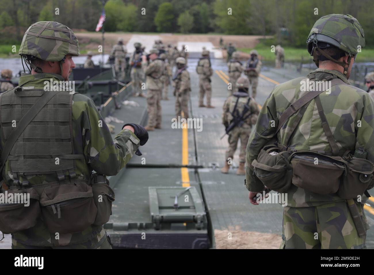 Swedish soldiers examine the bridge across the Narew River with U.S ...