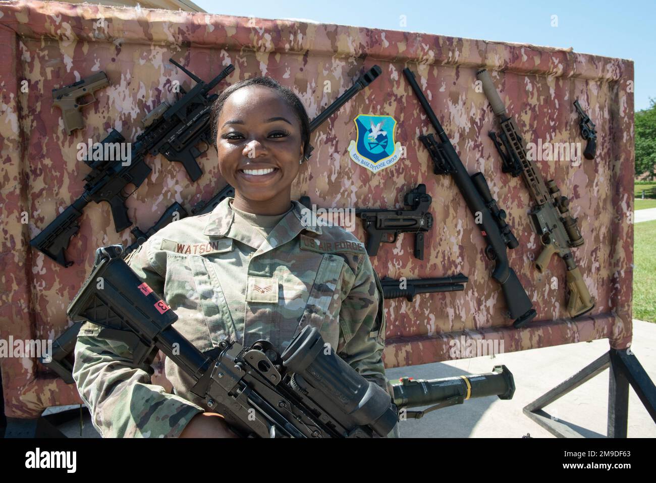 U.S. Air Force Senior Airman Tyra Watson stands with an M60 machine gun ...