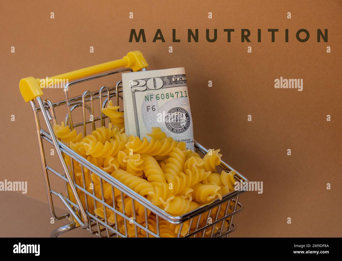 MALNUTRITION text against Shopping trolley cart Filled With Pasta with ...