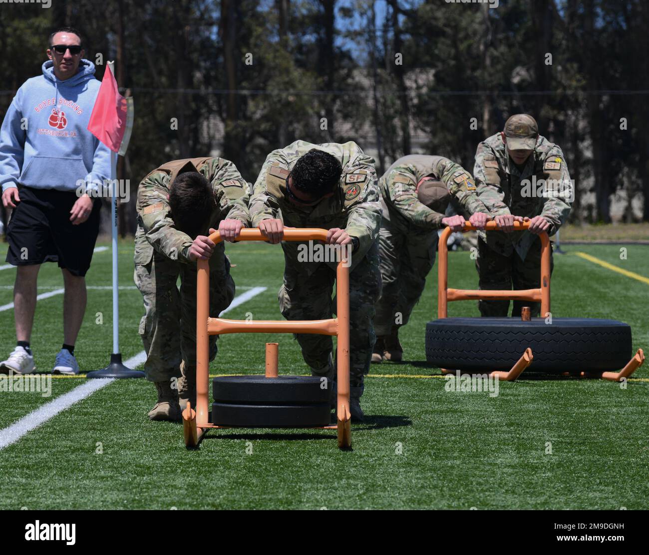 Defenders assigned to the 30th Security Forces Squadron push a weighted ...