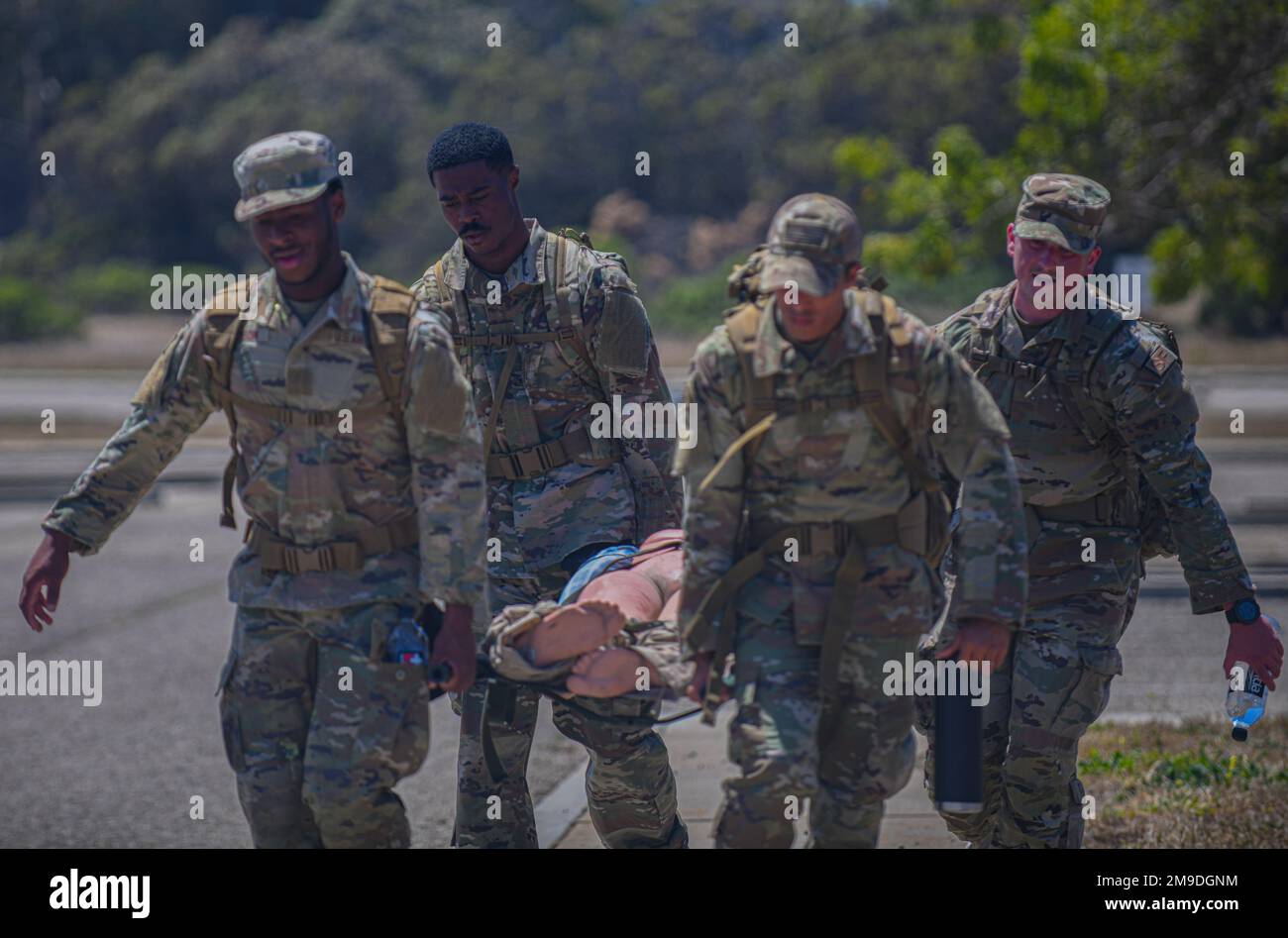 Defenders assigned to the 30th Security Forces Squadron carry a 200 lb ...