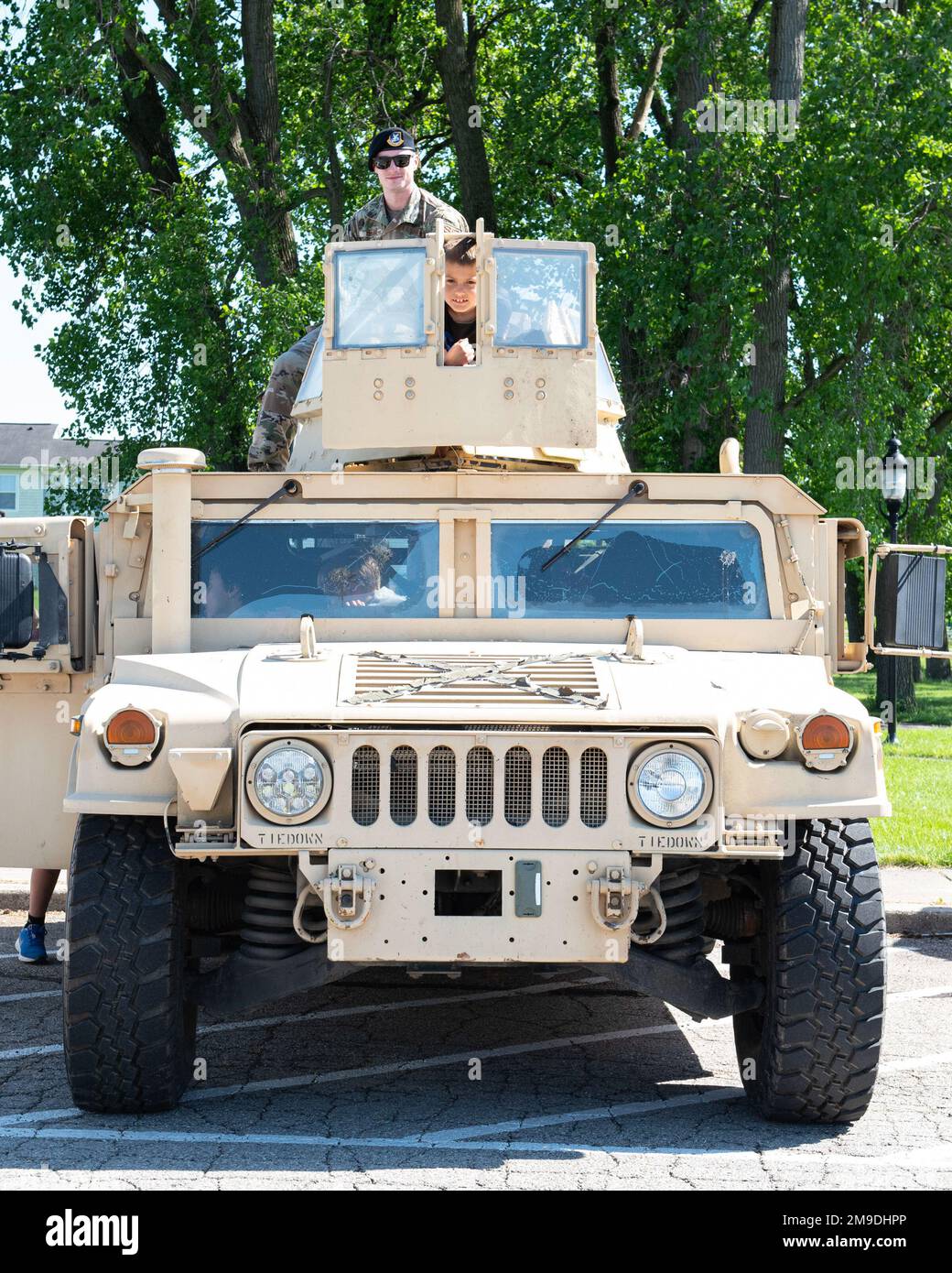 A child peeks through the turret of a Humvee, May 17, 2022, during ...