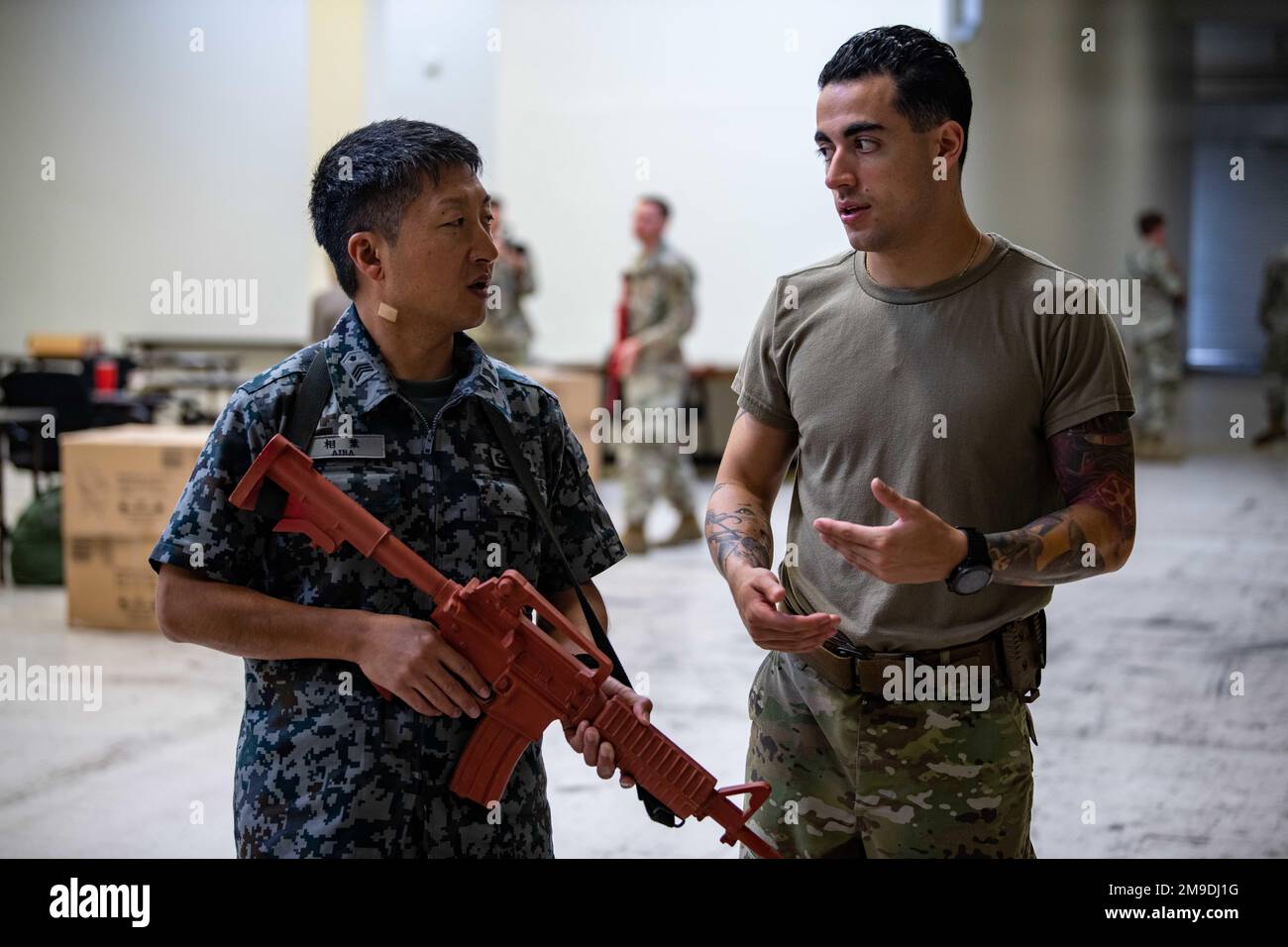 Japan Air Self-Defense Force Master Sgt. Kego Aiba, left, listens to ...