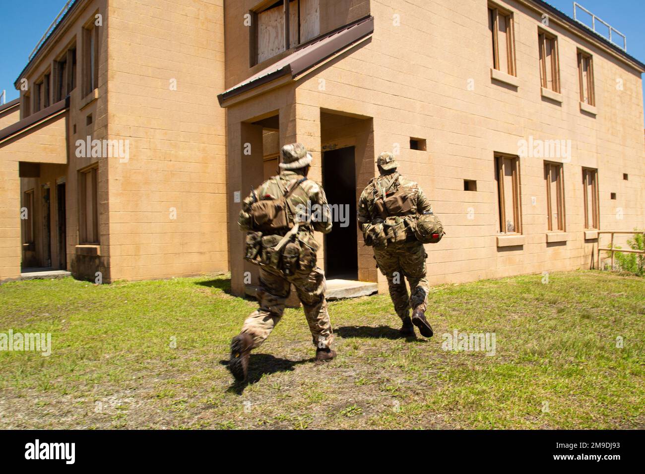 The Royal Bermuda Regiment advance toward a simulated hostile building ...