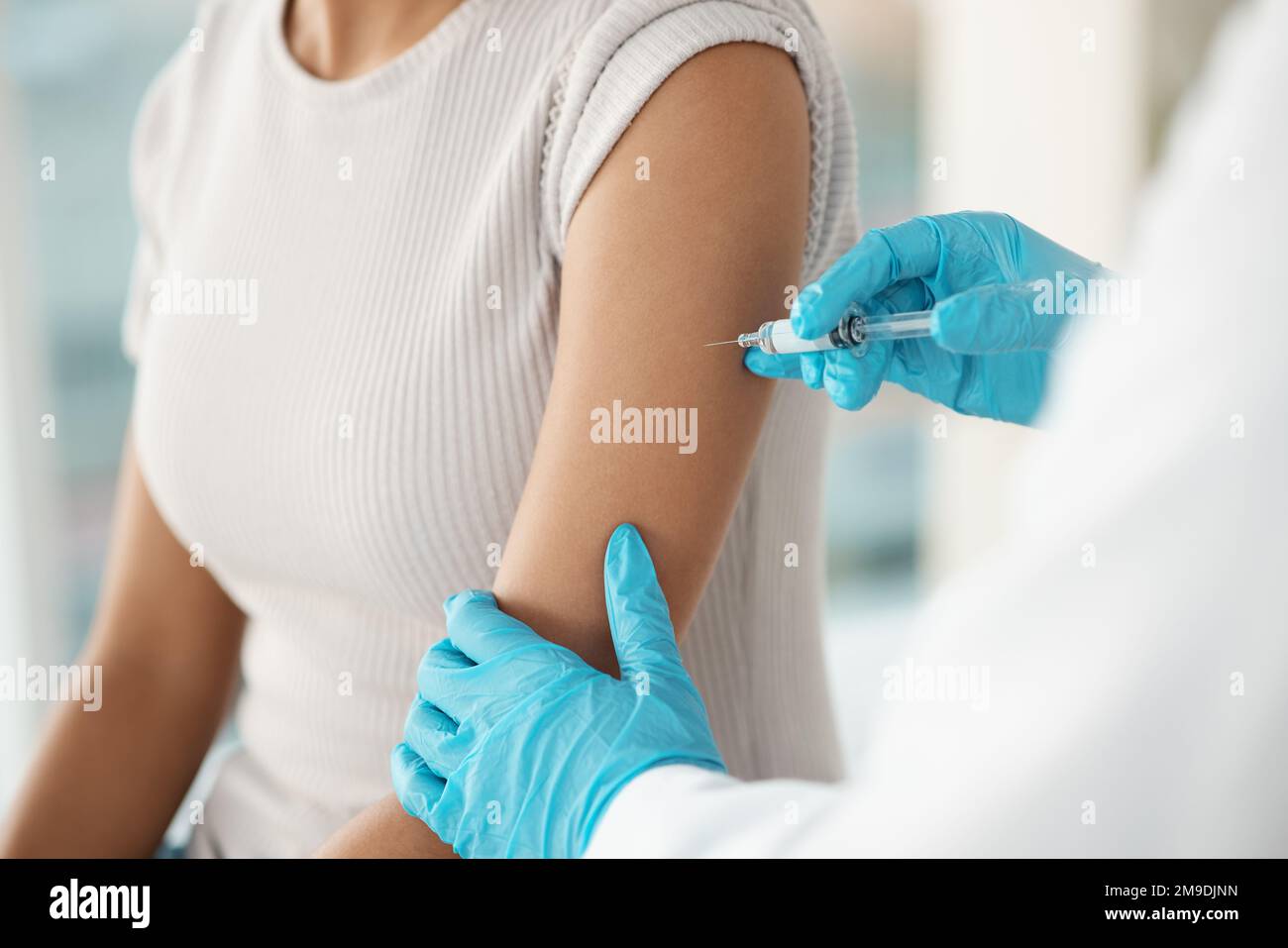 On three...an unrecognisable doctor standing and injecting her patient ...