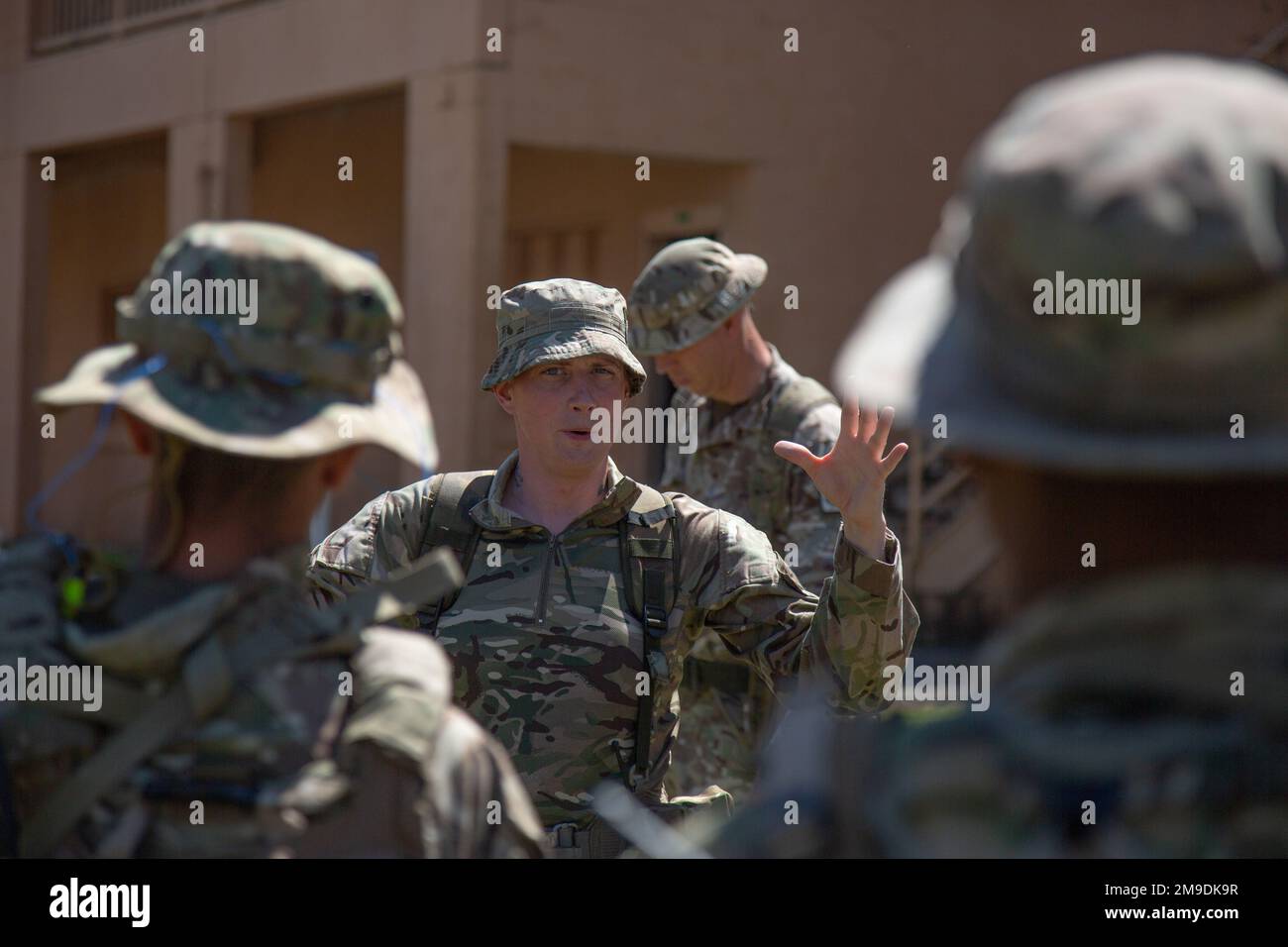 A service member of the British 4th Armoured Brigade conducts a brief ...