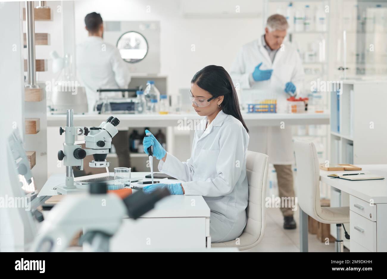 Analysing the sample extensively. a young scientist working with ...