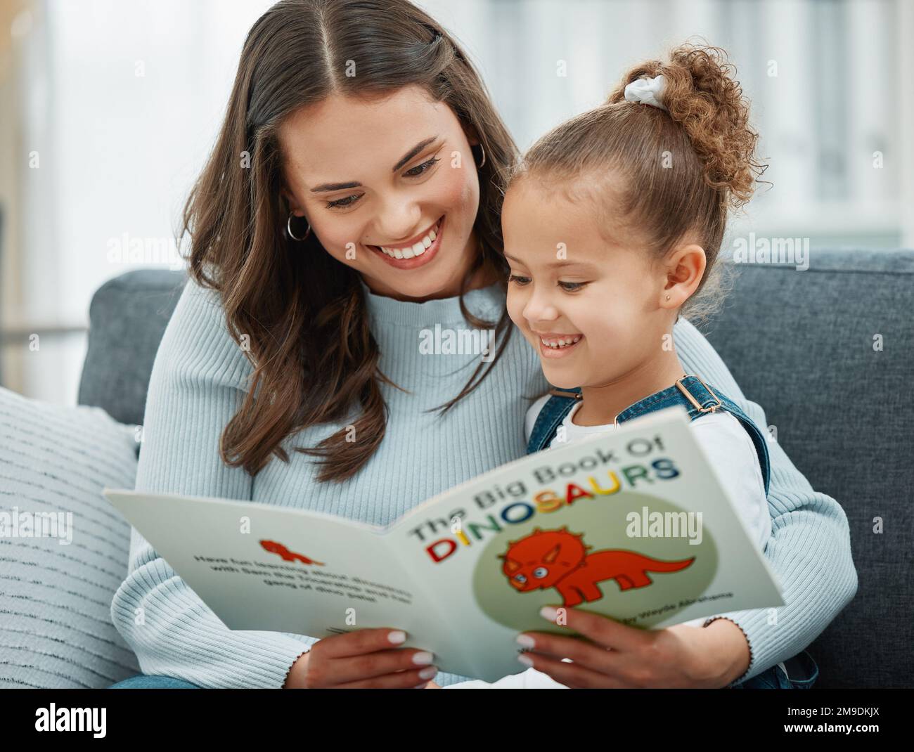 Your story is still being written. a young mother reading to her ...