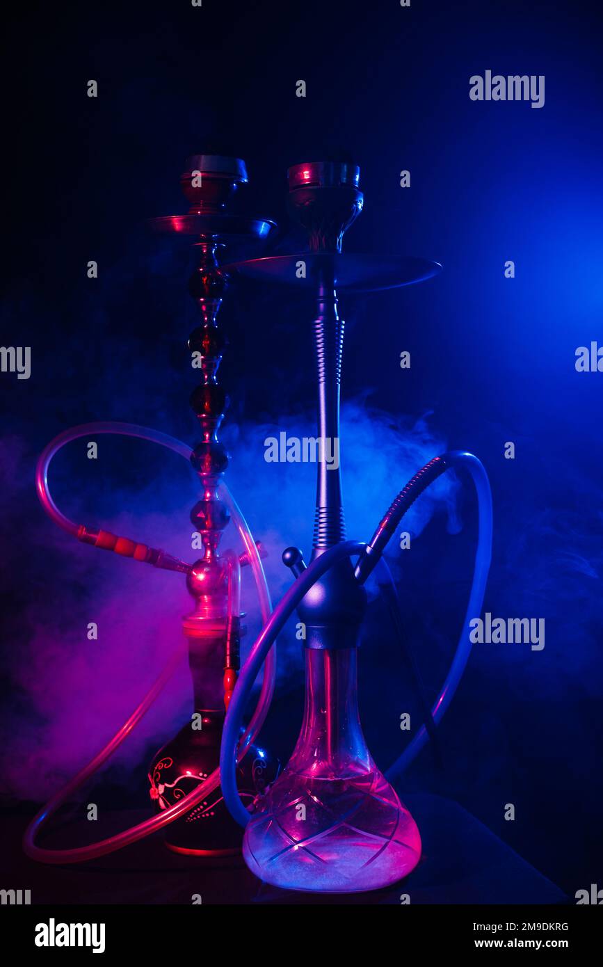 Fashionable hookah with cloud of smoke on a black background with red ...