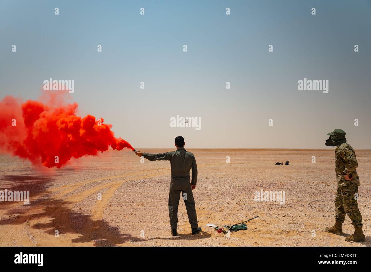 A Royal Air Force of Oman pilot, center, uses a smoke flare to indicate ...