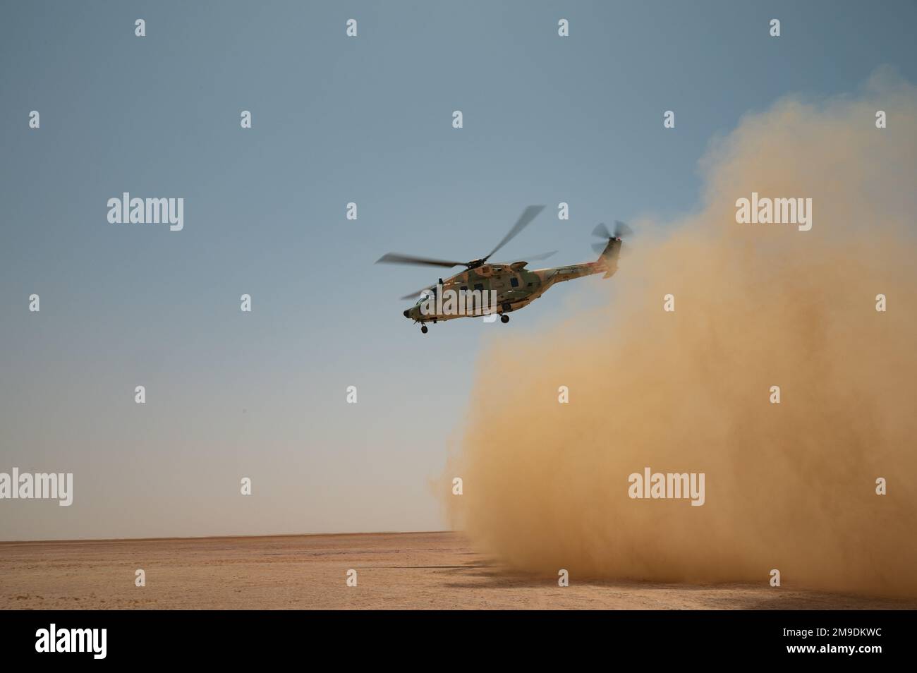A Royal Air Force of Oman helicopter lifts off from the desert in Oman ...