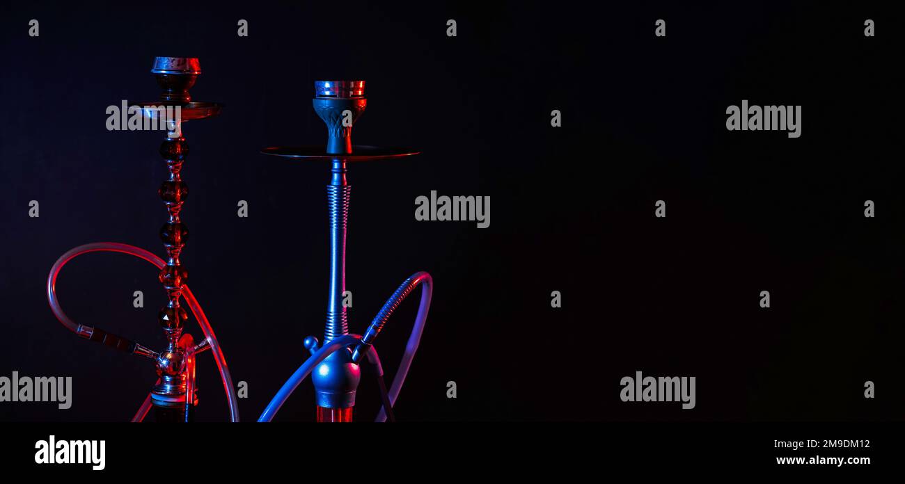 Modern hookah, shisha on black background with colored lighting and ...