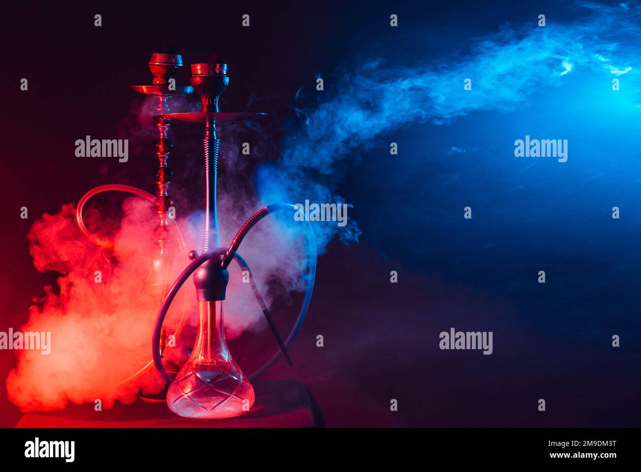 Modern hookah, shisha on smoky black background with neon lighting and ...