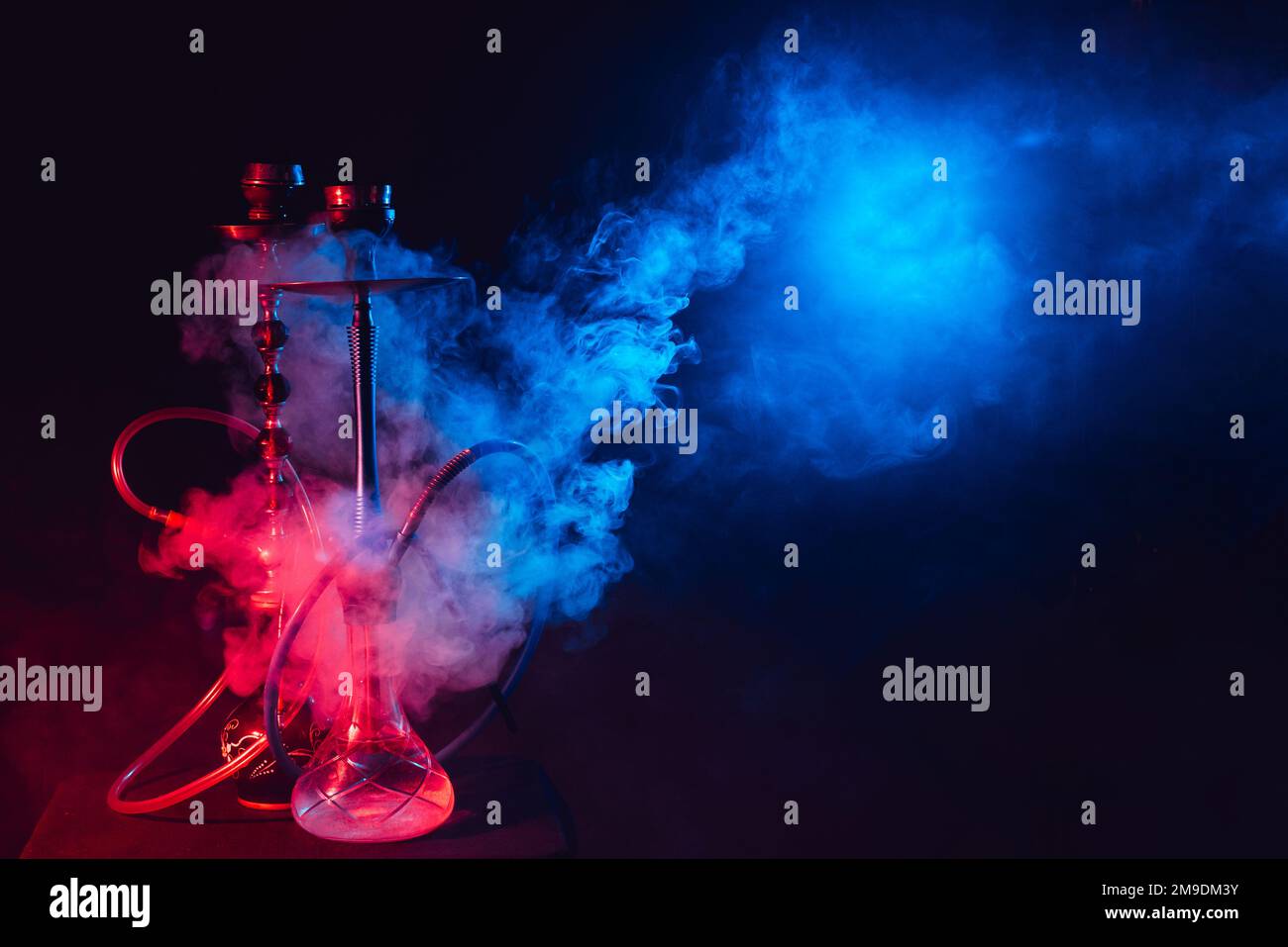 Modern hookah, shisha on smoky black background with neon lighting and ...