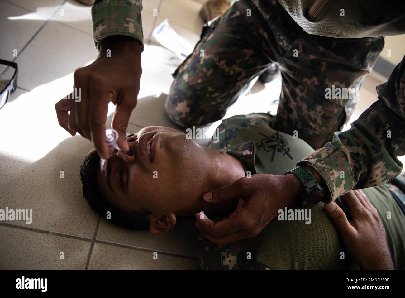 Members of the Maldives National Defense Forces practice applying a ...