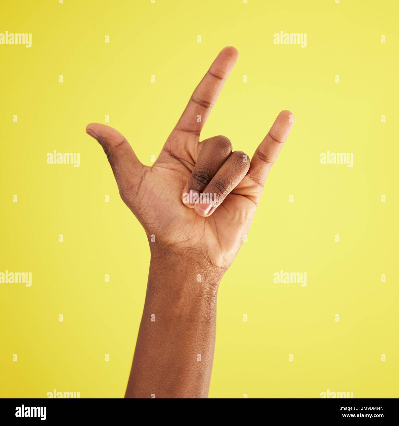 Rock on you rebel. Studio shot of an unrecognisable man making a horn ...