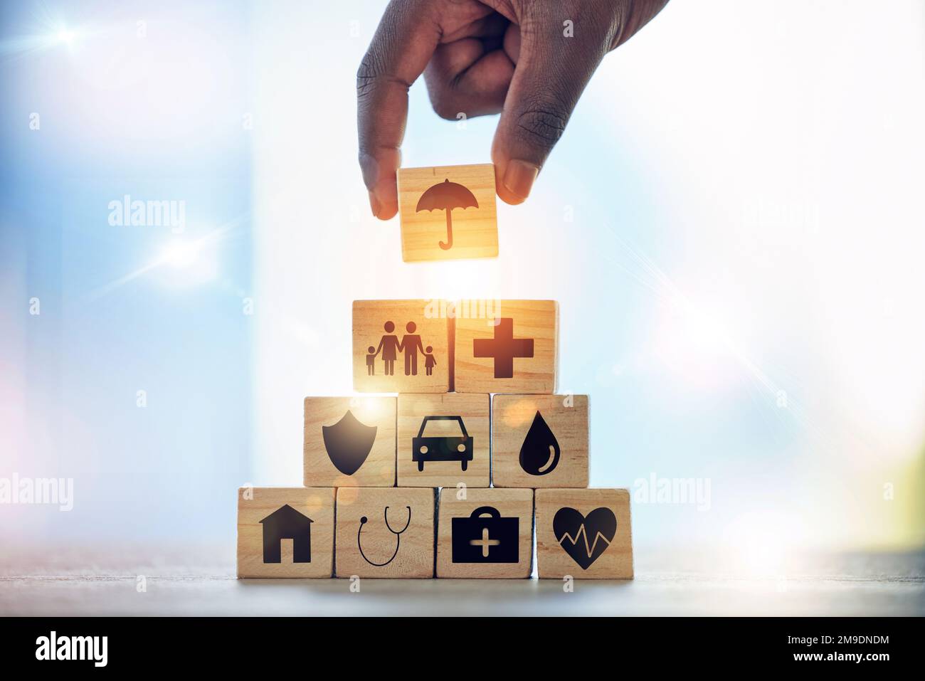 Take cover. an unrecognisable man assembling wooden blocks with ...