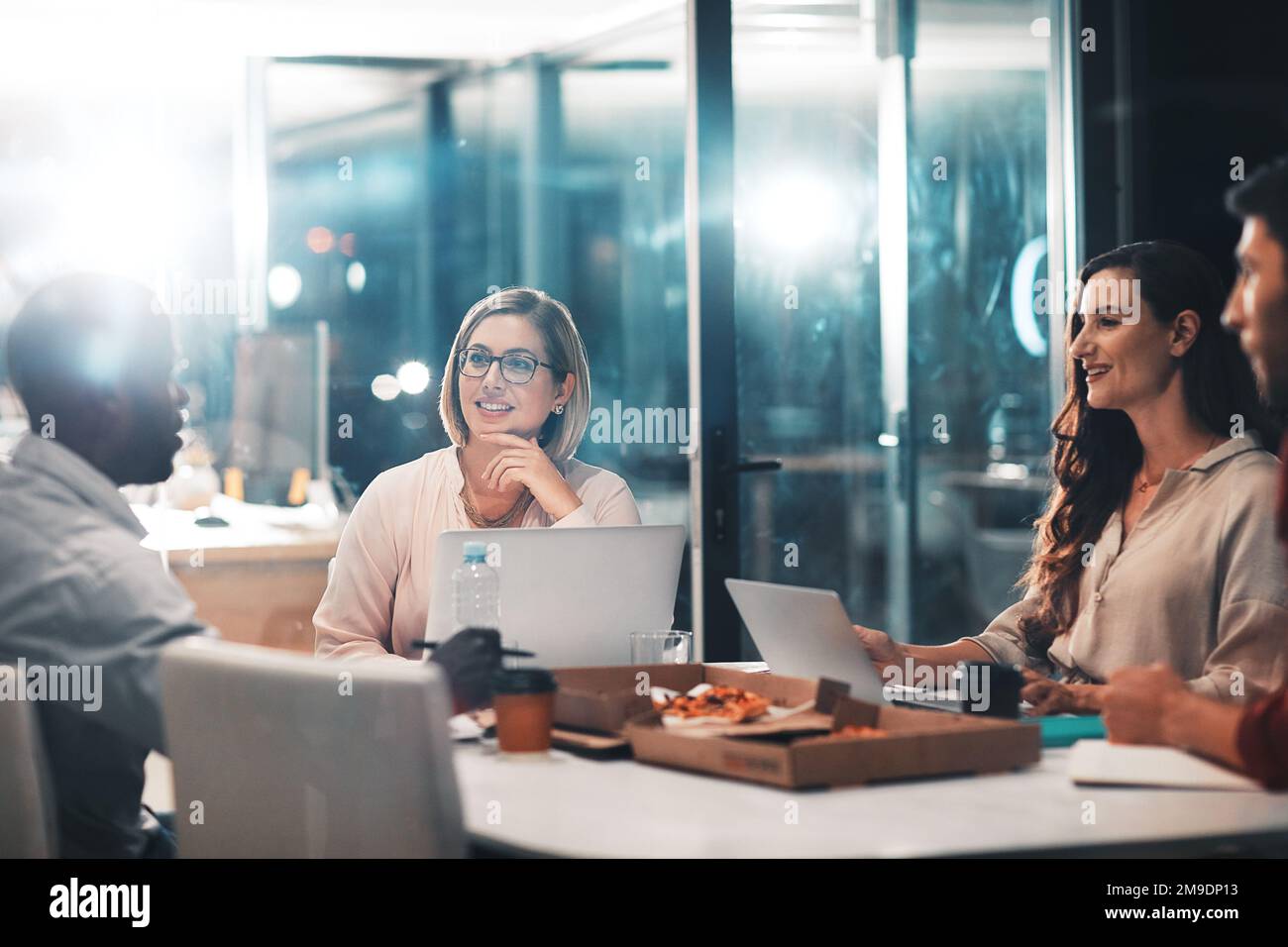 Business, late night and team at workshop with ideas, laptop and pizza ...