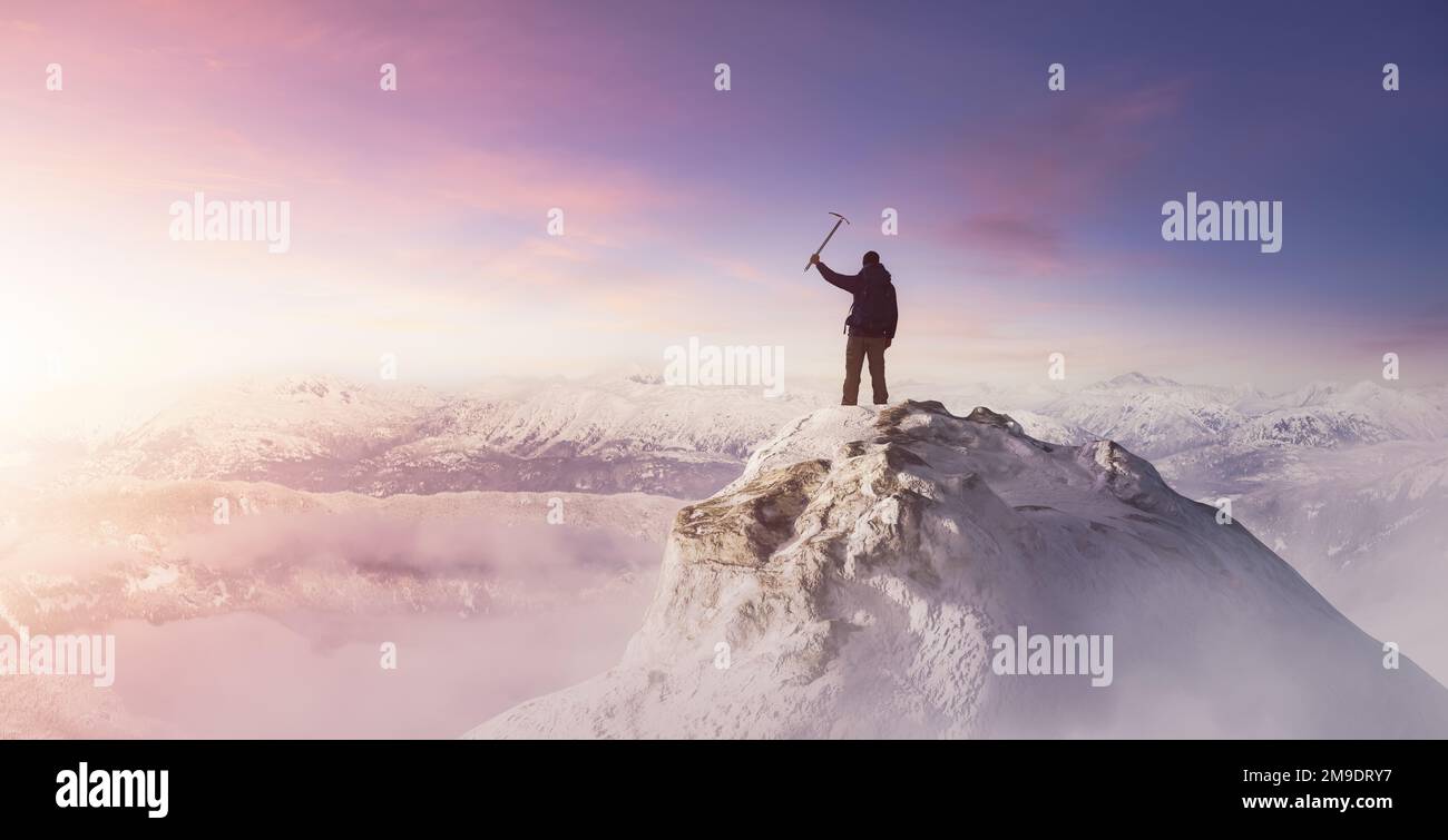 Adventurous Man Hiker standing on top of icy peak with rocky mountains ...