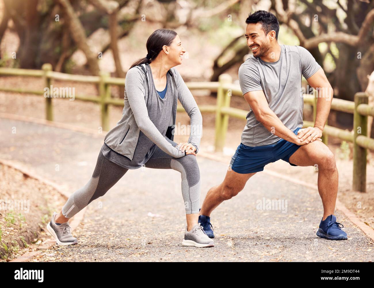 Go longer, grow stronger. a young couple stretching before their ...