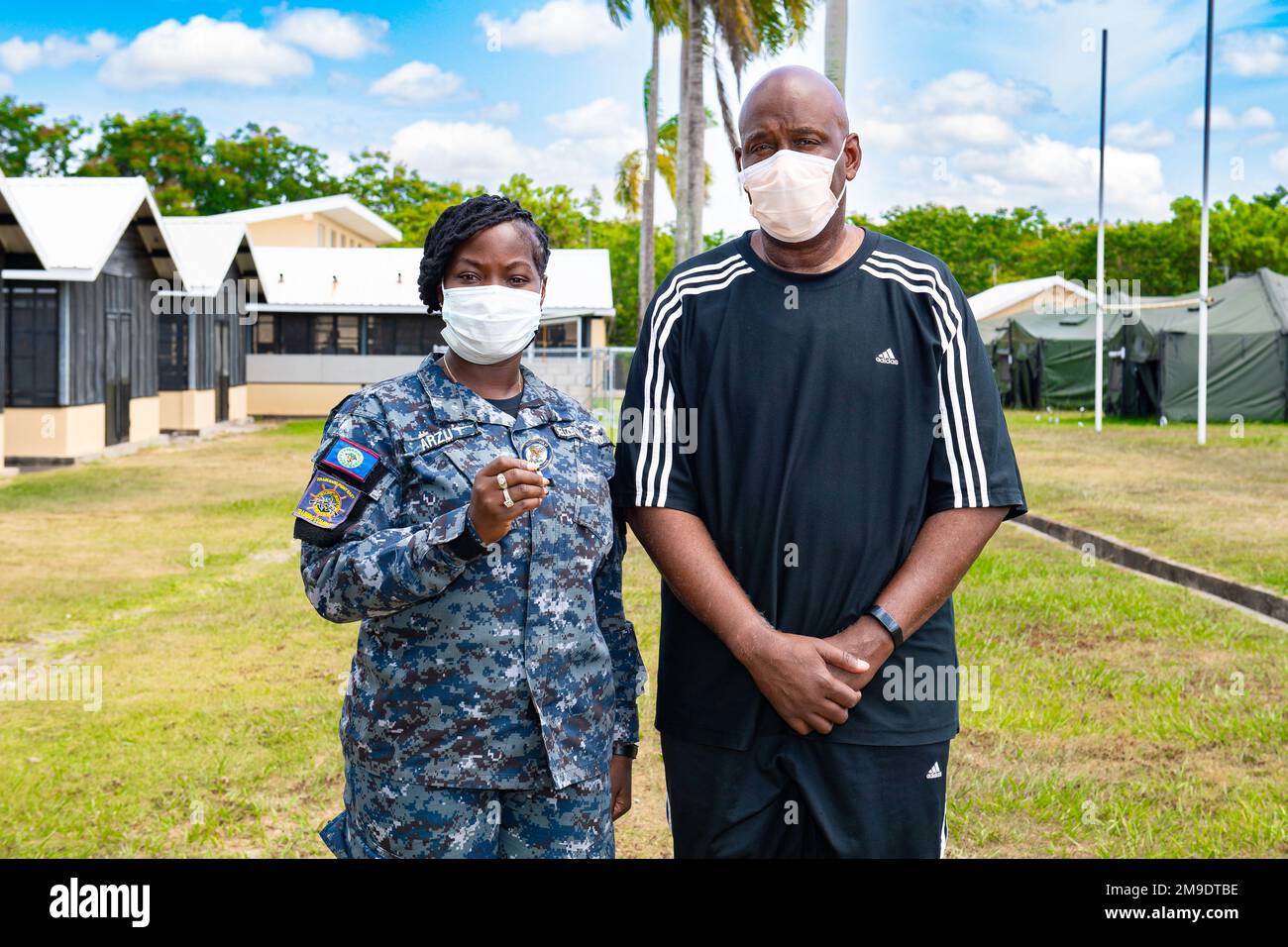 Lieutenant Junior Grade Sarah Arzu (left) received a coin from U.S. Southern Command, Director ...