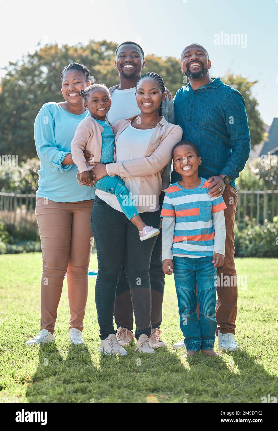 Whenever you have free time, spend it with family. a multi-generational family standing together ...