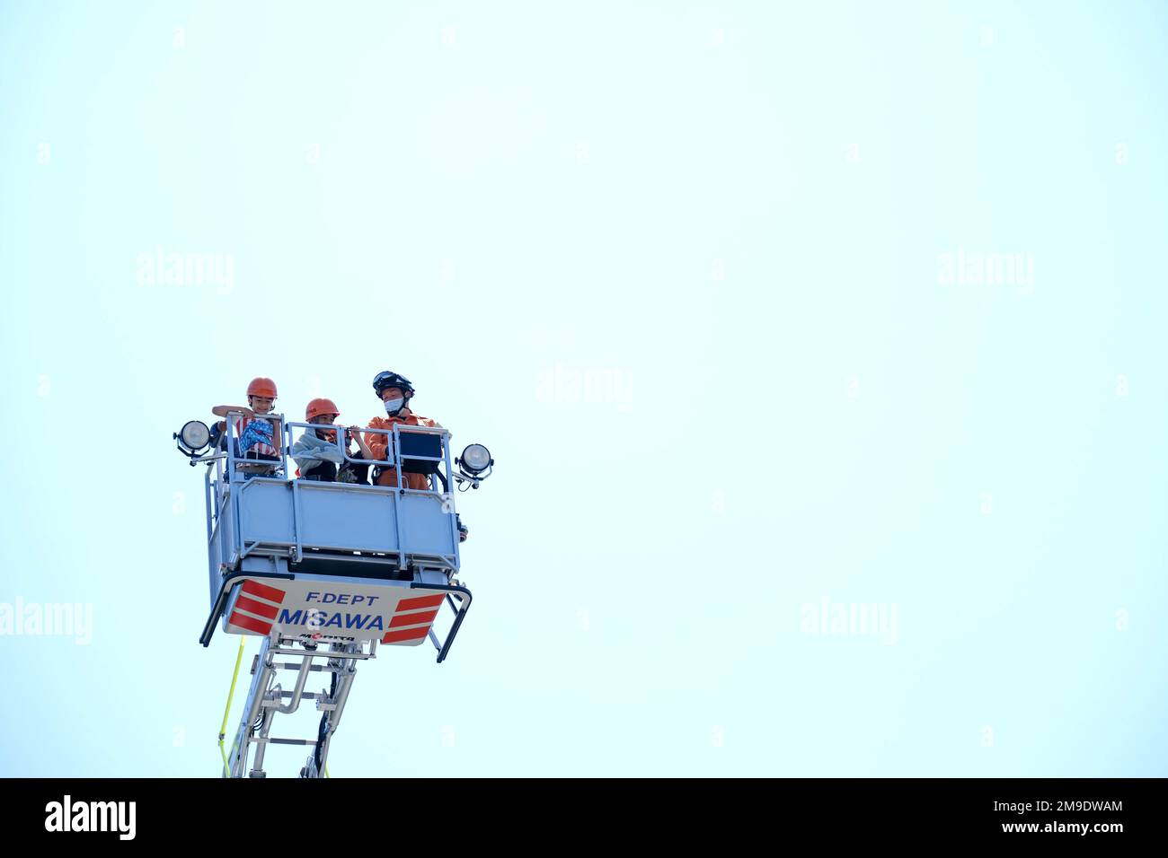 Children and a member of the Misawa CIty Fire Department ride the fire ...