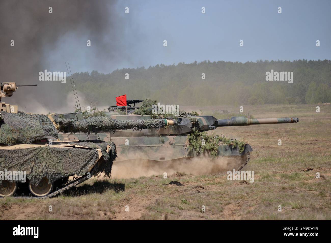A Polish Leopard 2A tank maneuvers past a U.S. Army M1A2 Abrams tank to ...